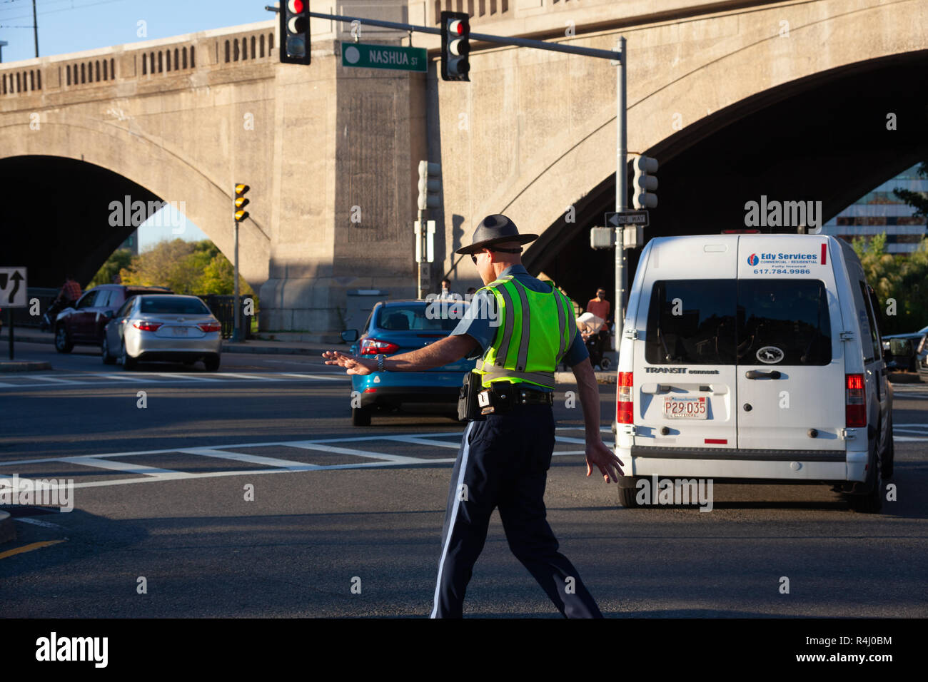 A State Police officer directing traffic at Charles River Dam Road in ...
