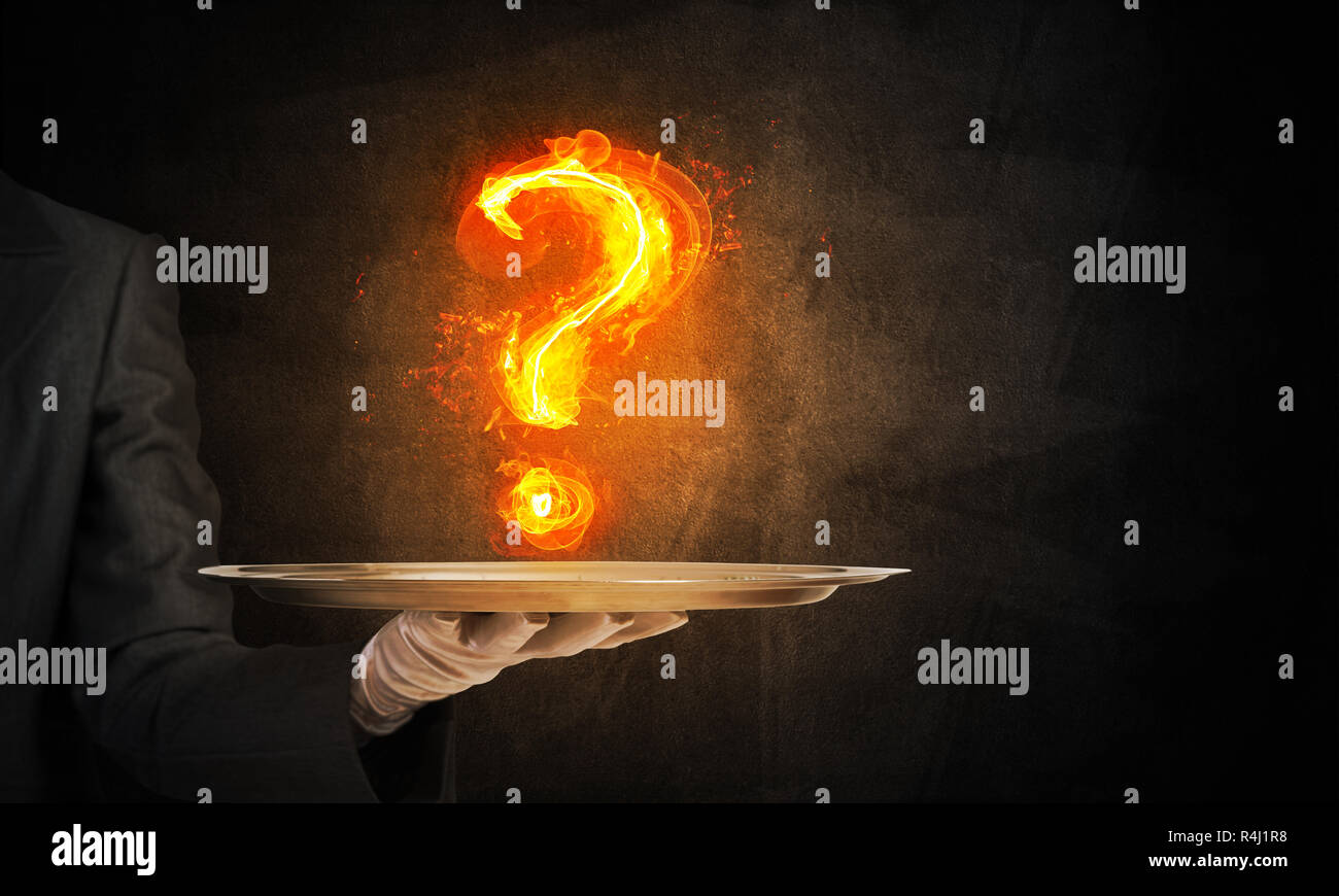 Hand of waitress presenting flaming question mark Stock Photo - Alamy