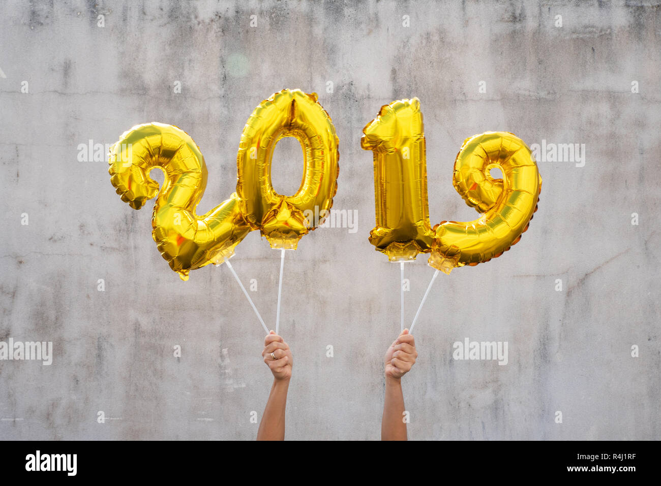 Hands holding golden 2019 balloons, new year concept Stock Photo - Alamy