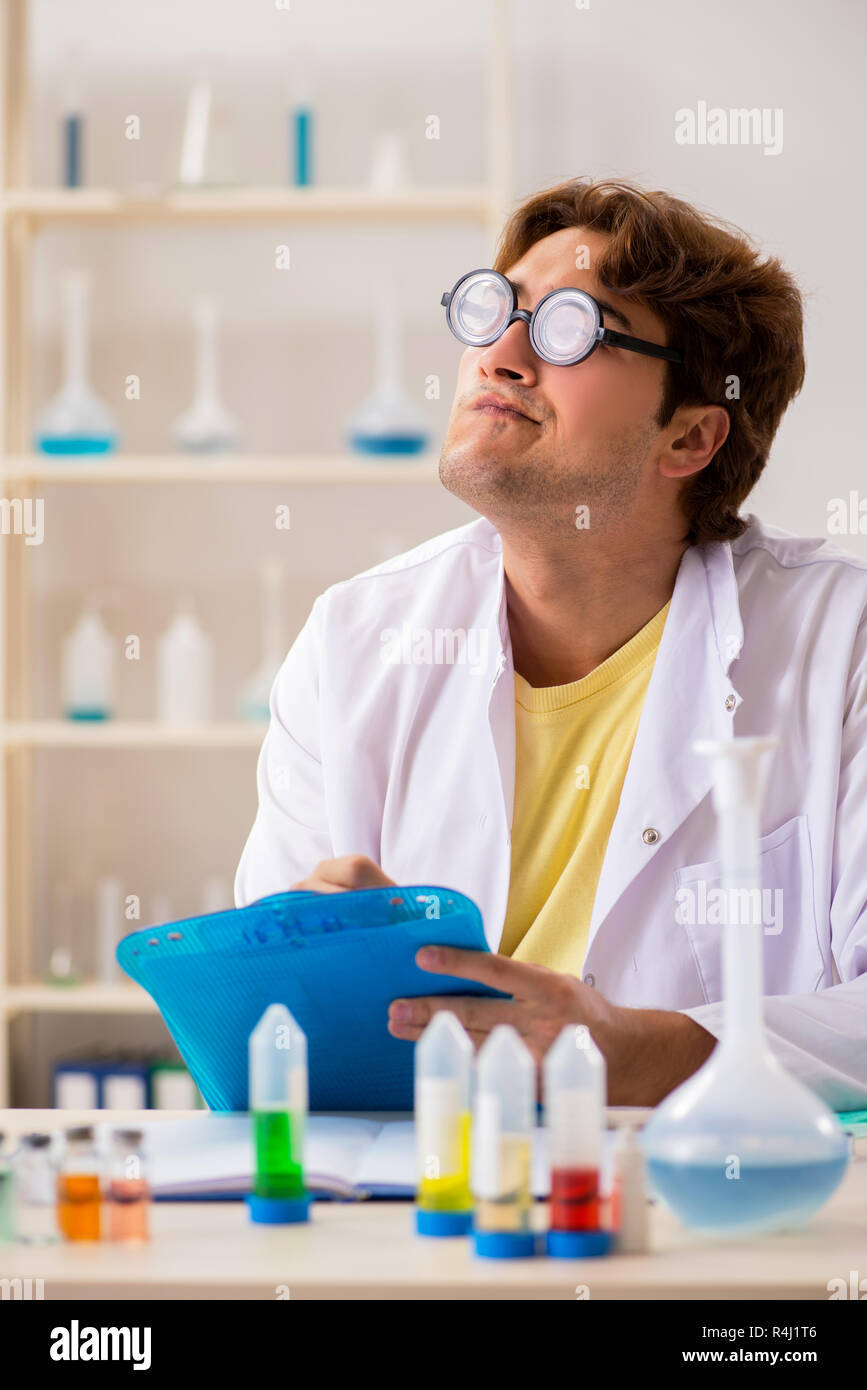 Funny crazy chemist doing experiments and tests Stock Photo - Alamy