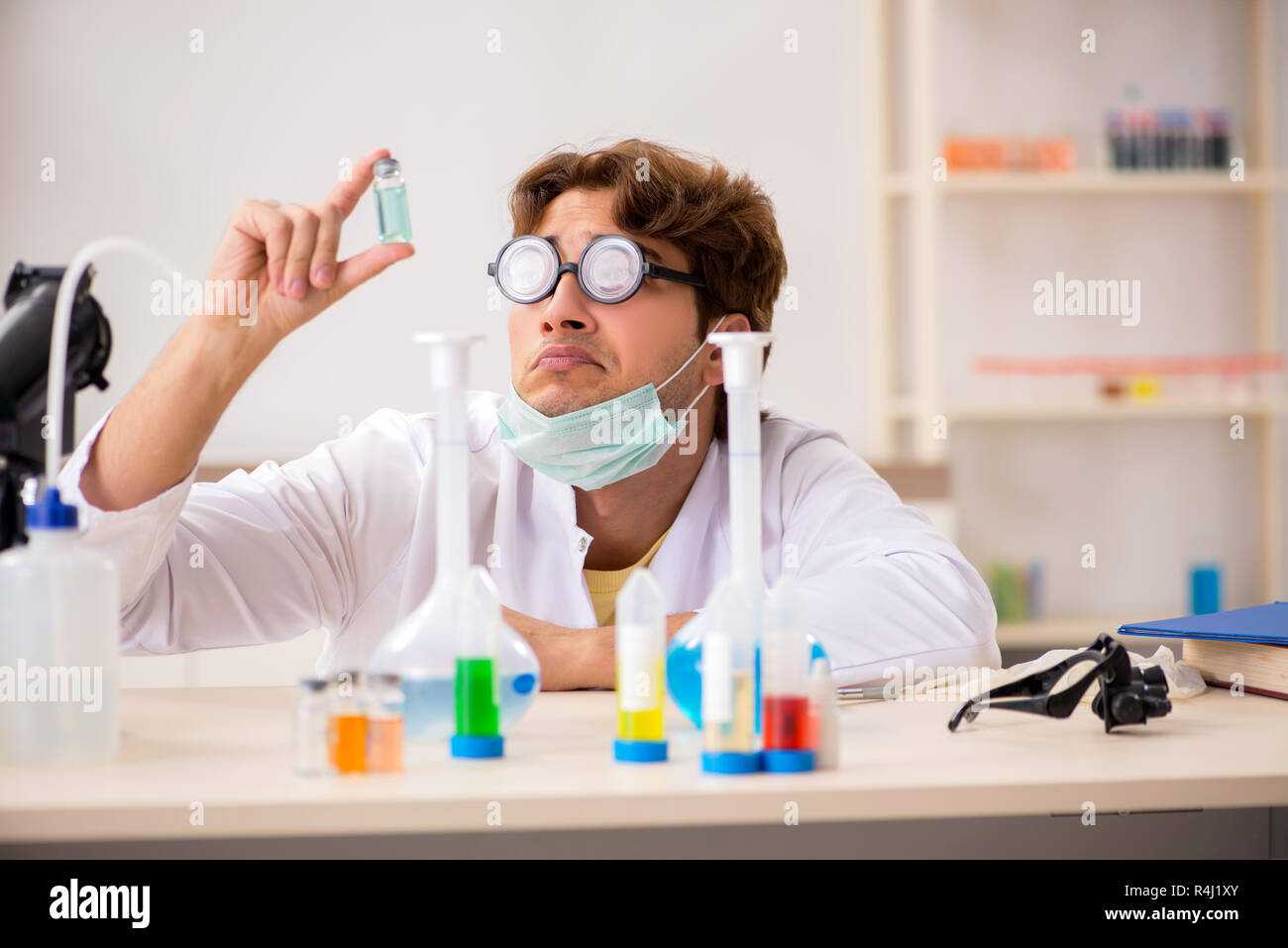 Funny crazy chemist doing experiments and tests Stock Photo - Alamy