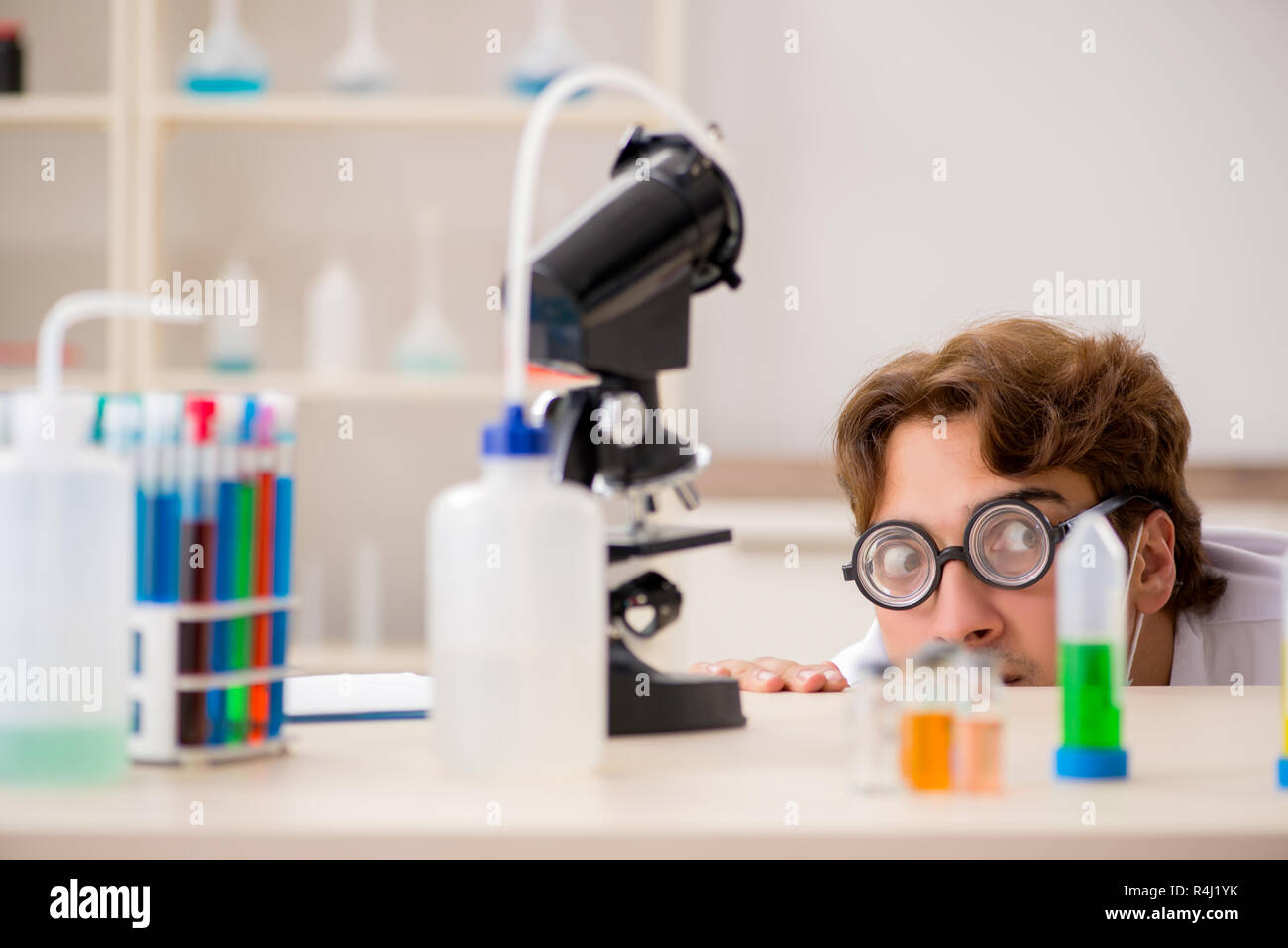 Funny crazy chemist doing experiments and tests Stock Photo - Alamy