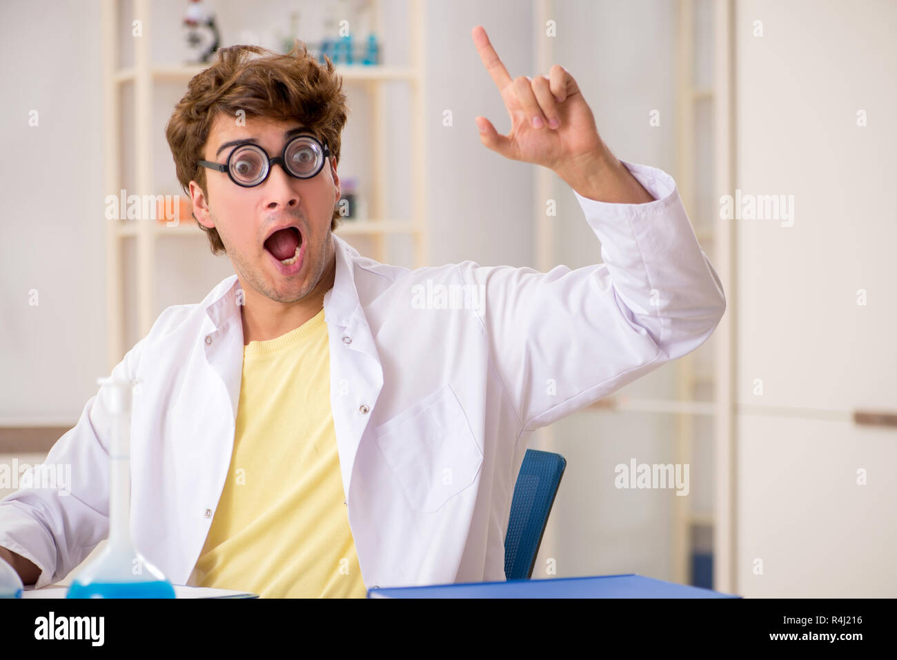 Funny crazy chemist doing experiments and tests Stock Photo - Alamy