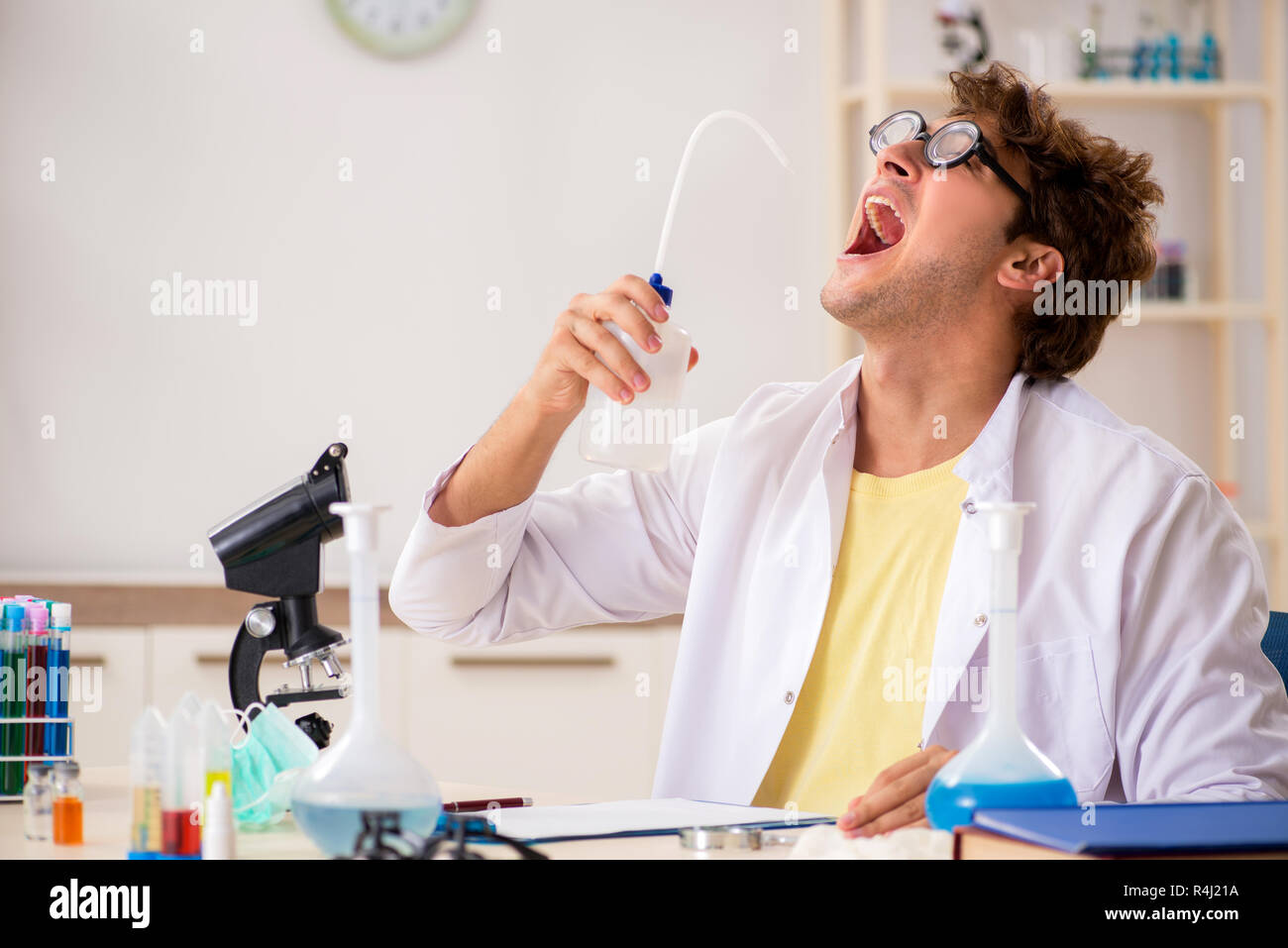 Funny crazy chemist doing experiments and tests Stock Photo - Alamy