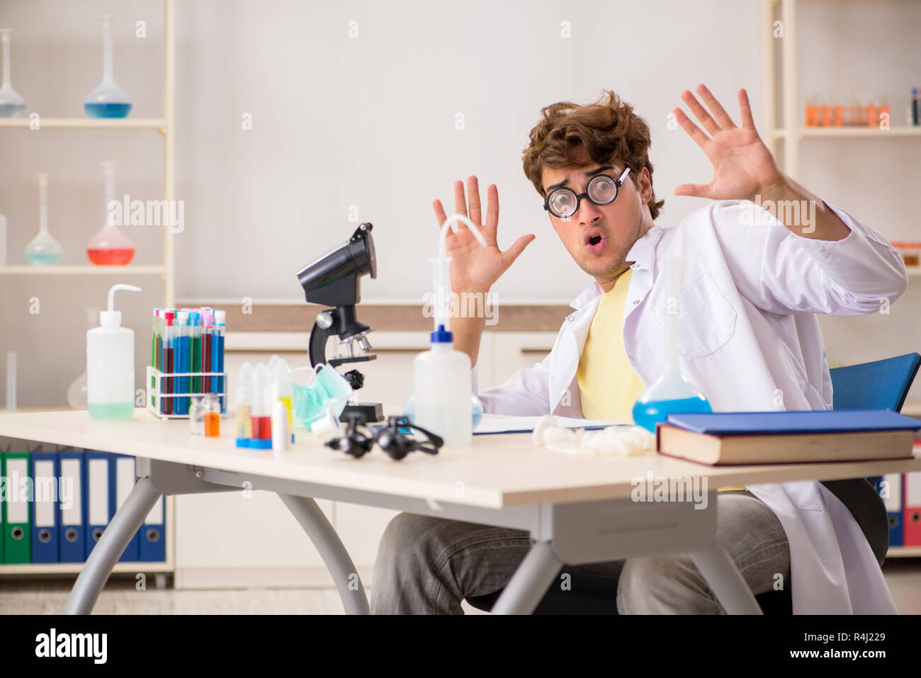 Funny crazy chemist doing experiments and tests Stock Photo - Alamy
