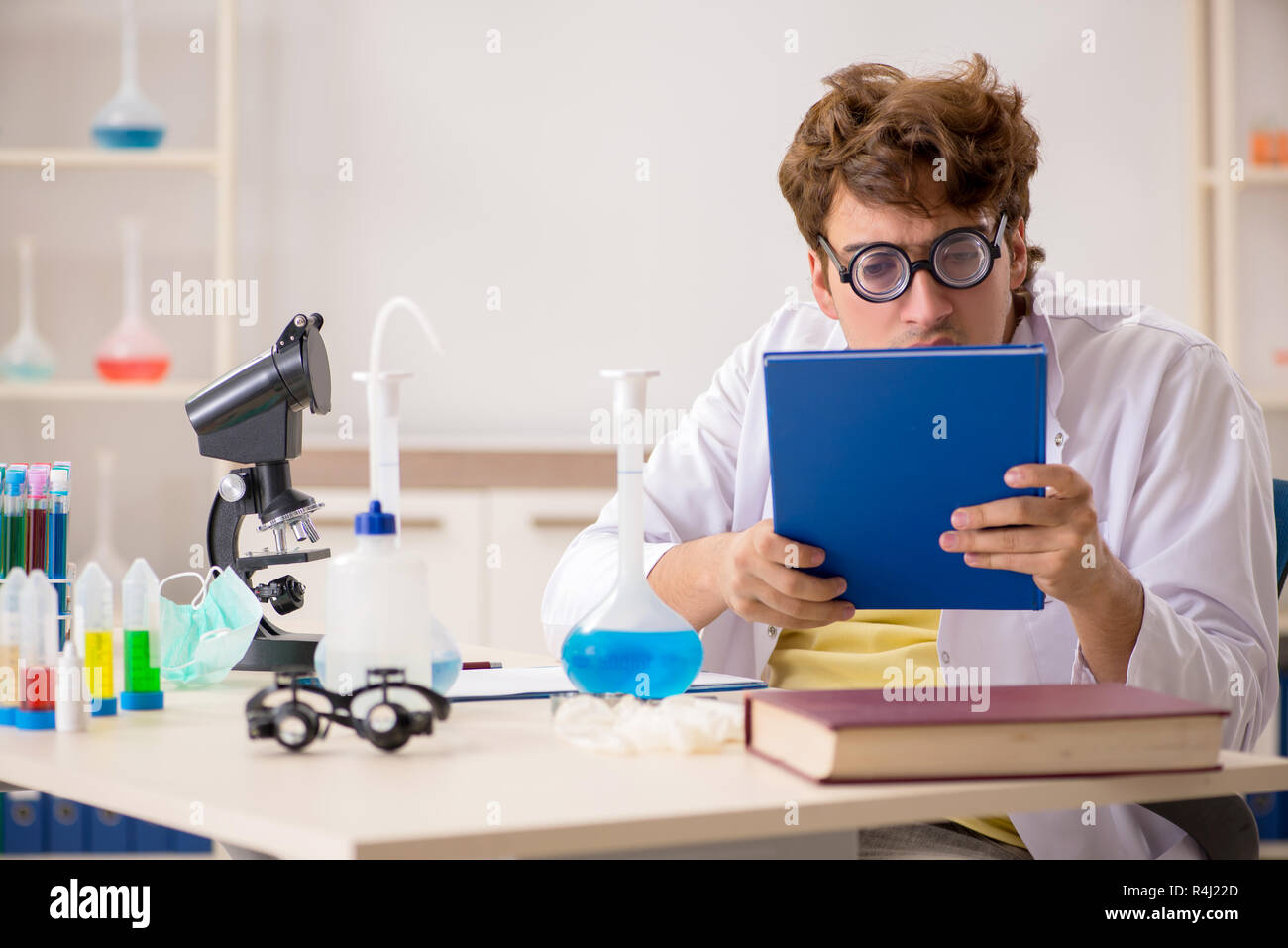 Funny crazy chemist doing experiments and tests Stock Photo - Alamy