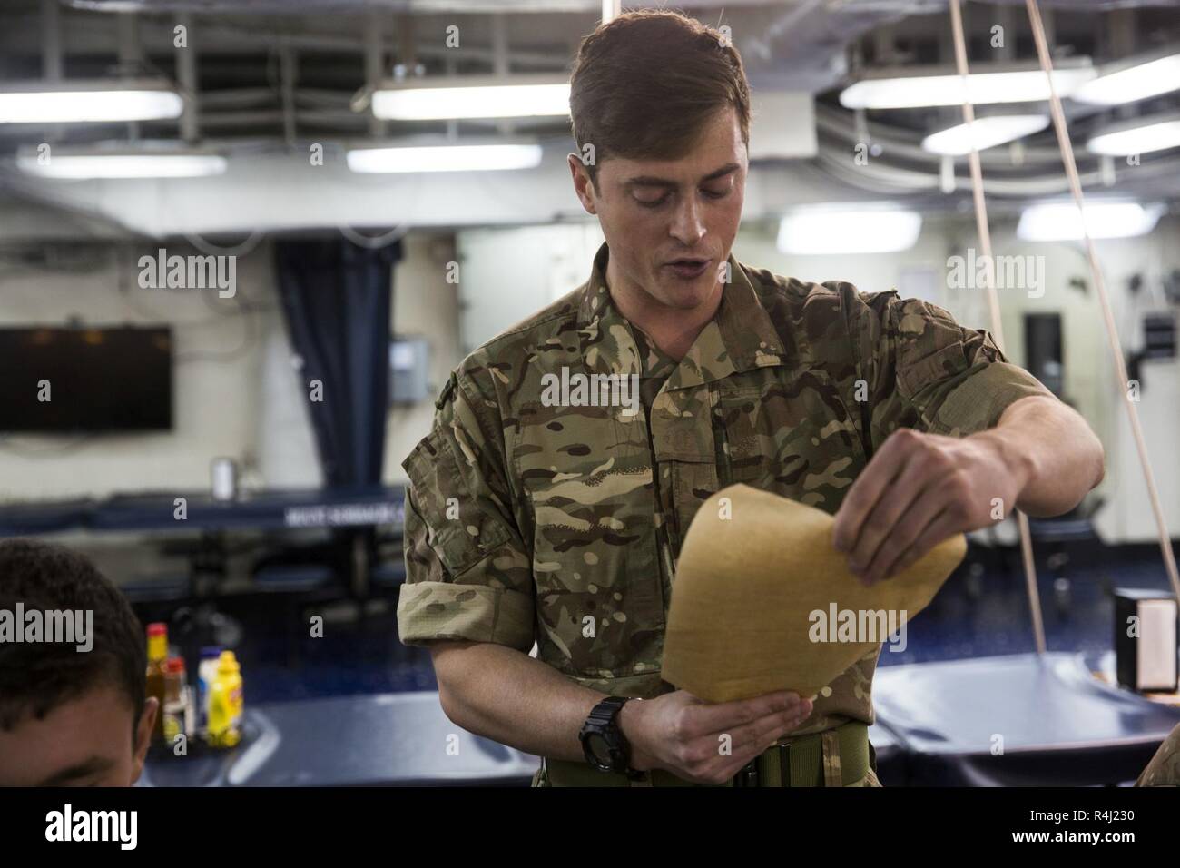British Royal Marine Ian Smith reads the convening order during the ...