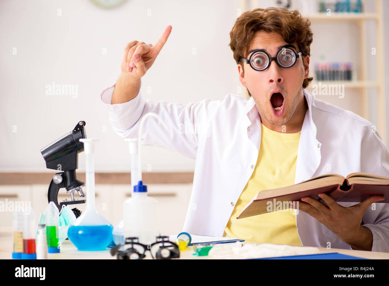 Funny crazy chemist doing experiments and tests Stock Photo - Alamy