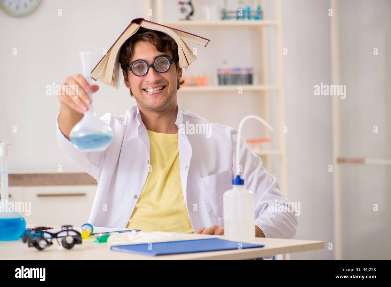 Funny crazy chemist doing experiments and tests Stock Photo - Alamy