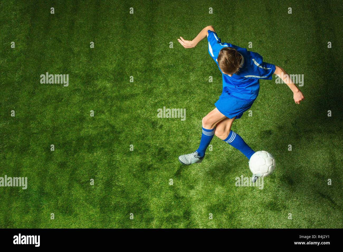 Young boy with soccer ball doing flying kick Stock Photo - Alamy