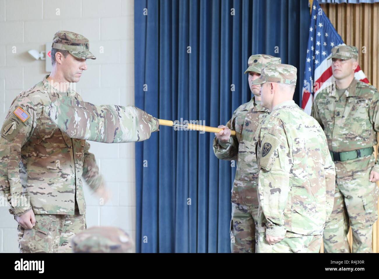 Command Sgt. Maj. Kevin Austin prepares to unveil the company guidon ...