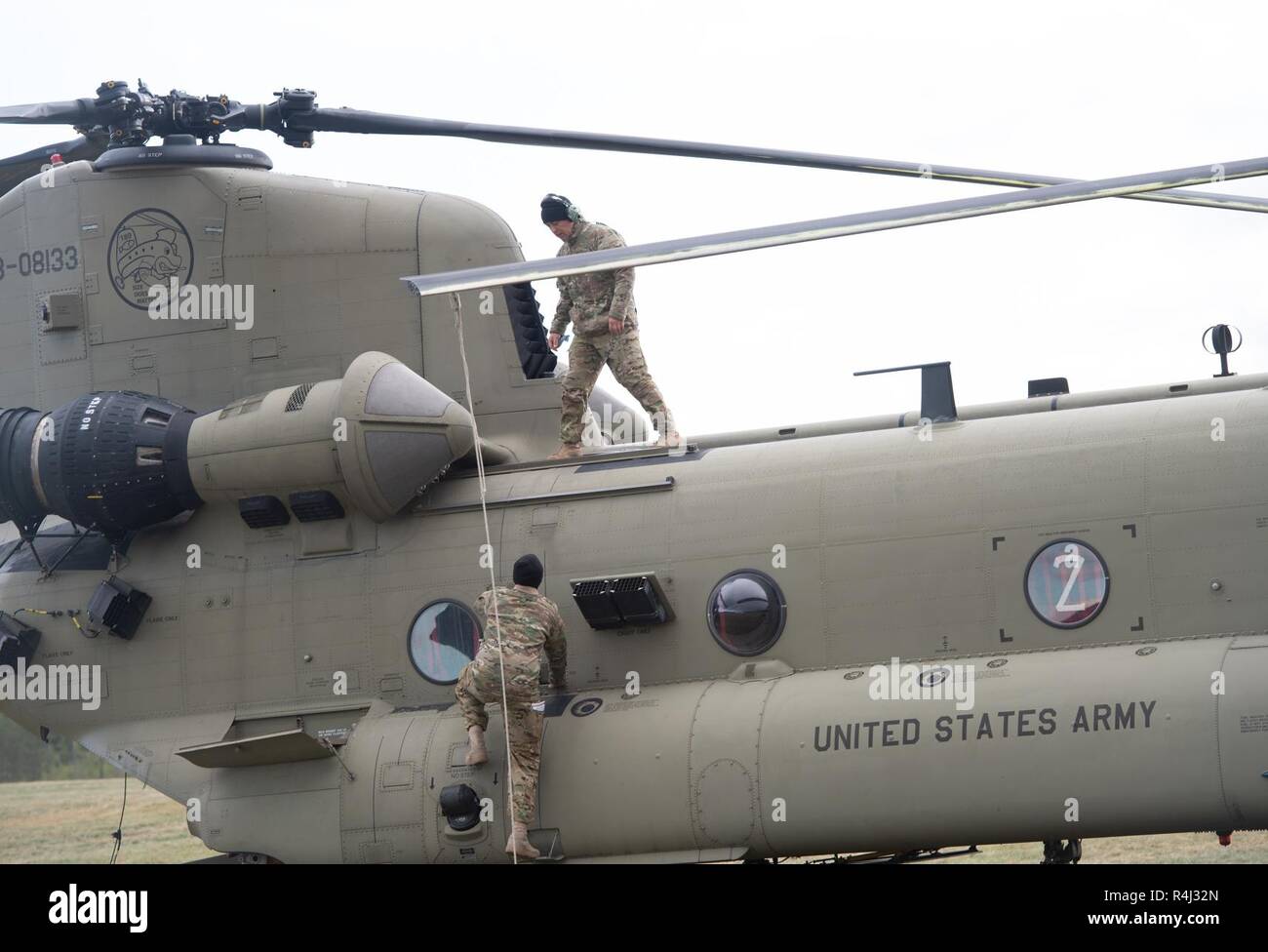U.S. Army crew chiefs from the 12th Combat Aviation Brigade preflight ...