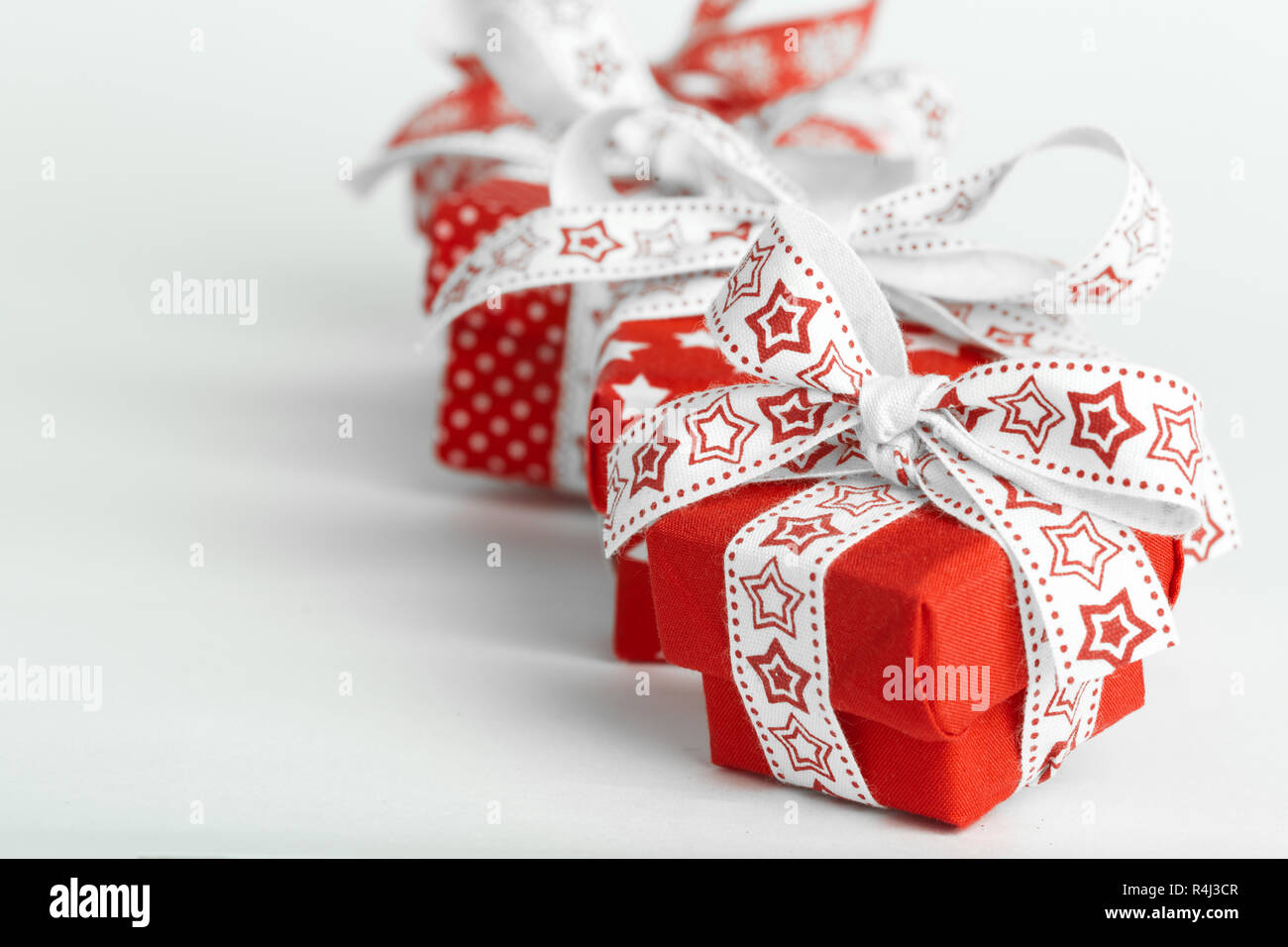 Red Christmas gift boxes on white background Stock Photo - Alamy