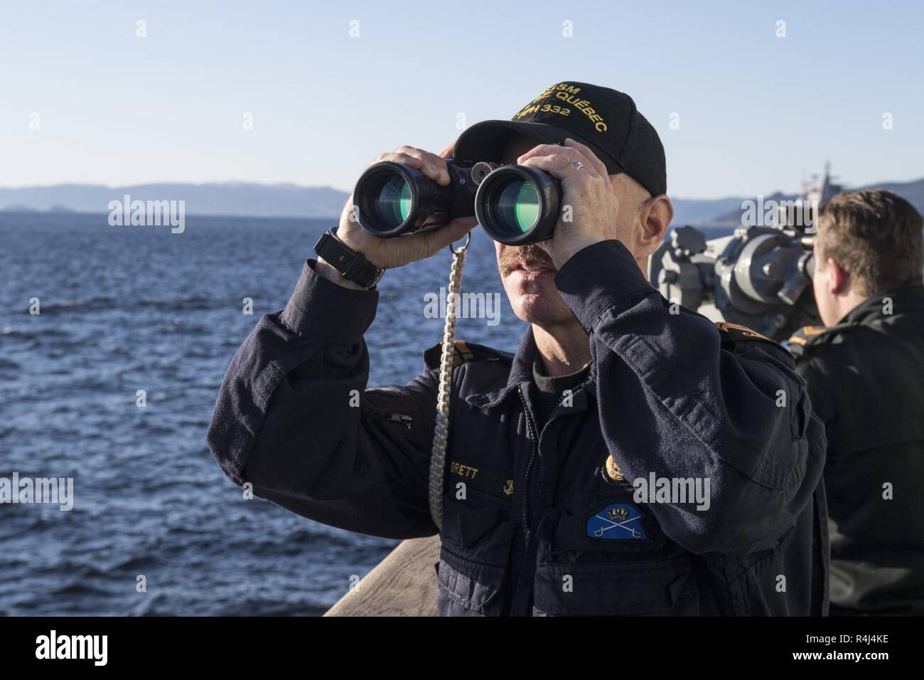 Lieutenant (Navy) Konnor Brett watches from the bridge wing of Her ...