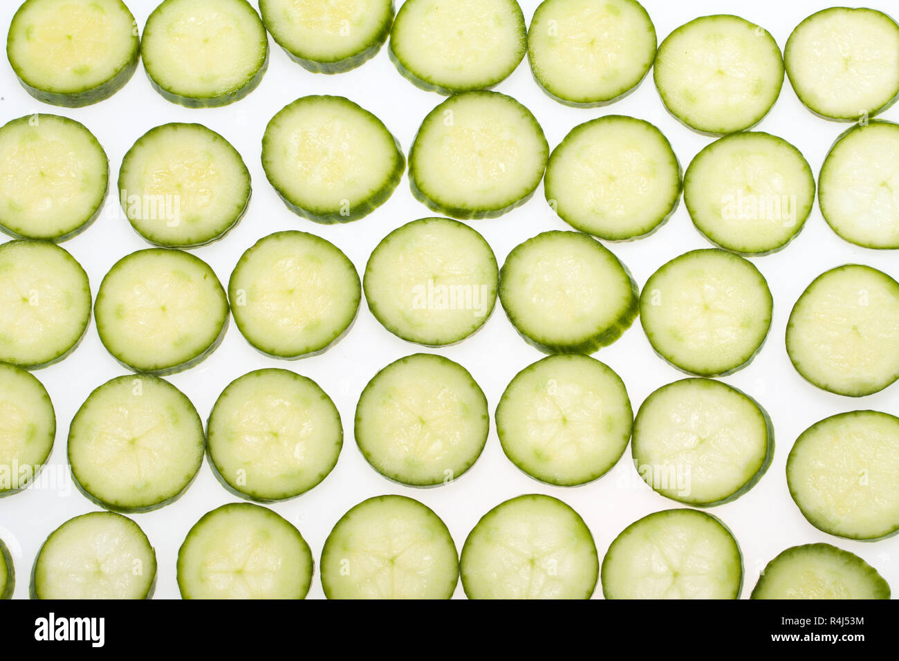 Freshly sliced cucumber isolated on white background Stock Photo - Alamy