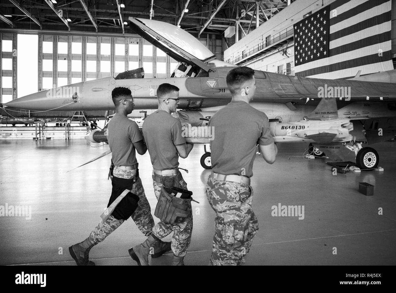 The 96th Aircraft Maintenance Squadron Blue Team carries an AIM-9X ...