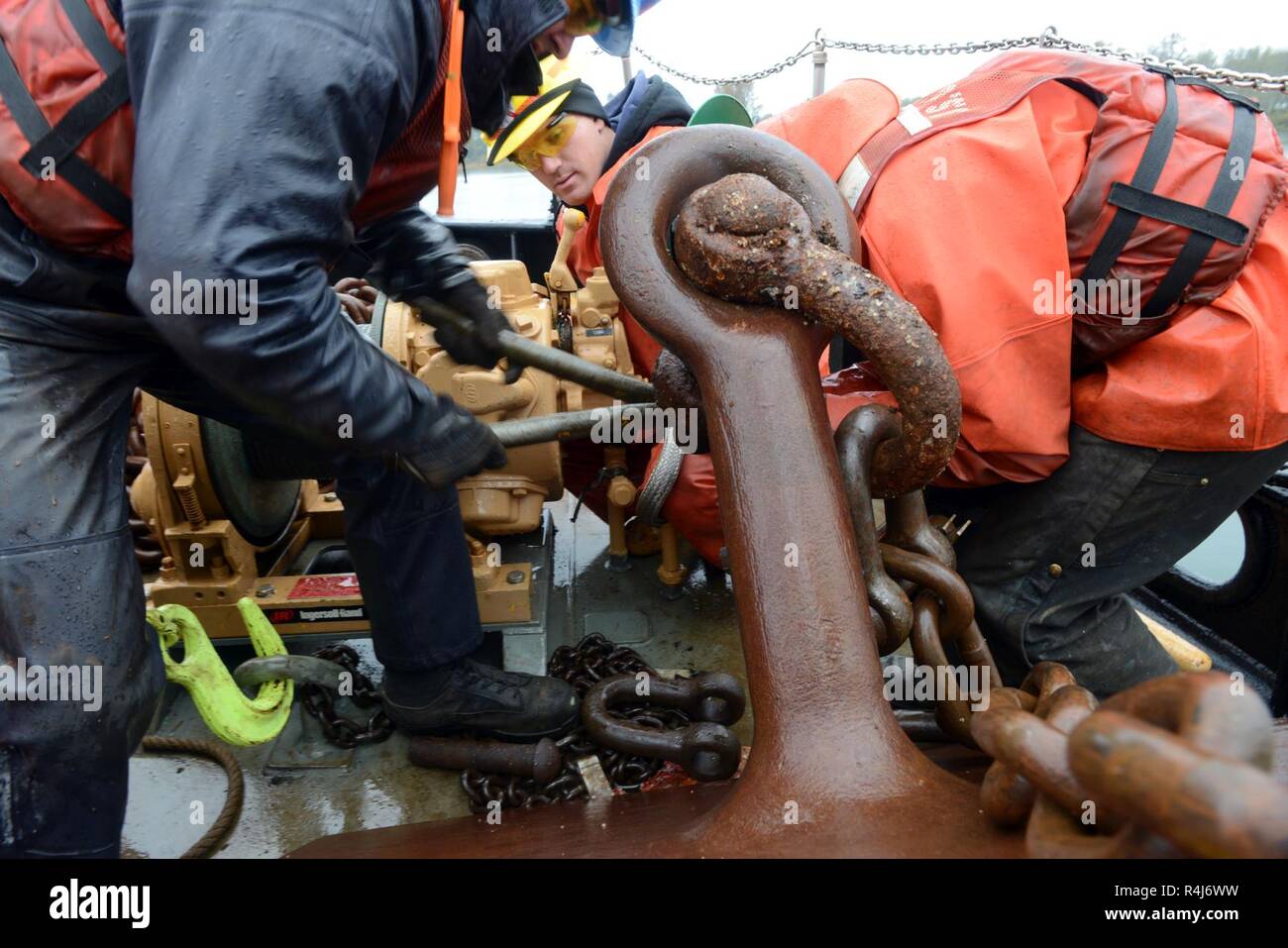 Crewmembers aboard the Coast Guard Cutter Bluebell bend the metal on a ...