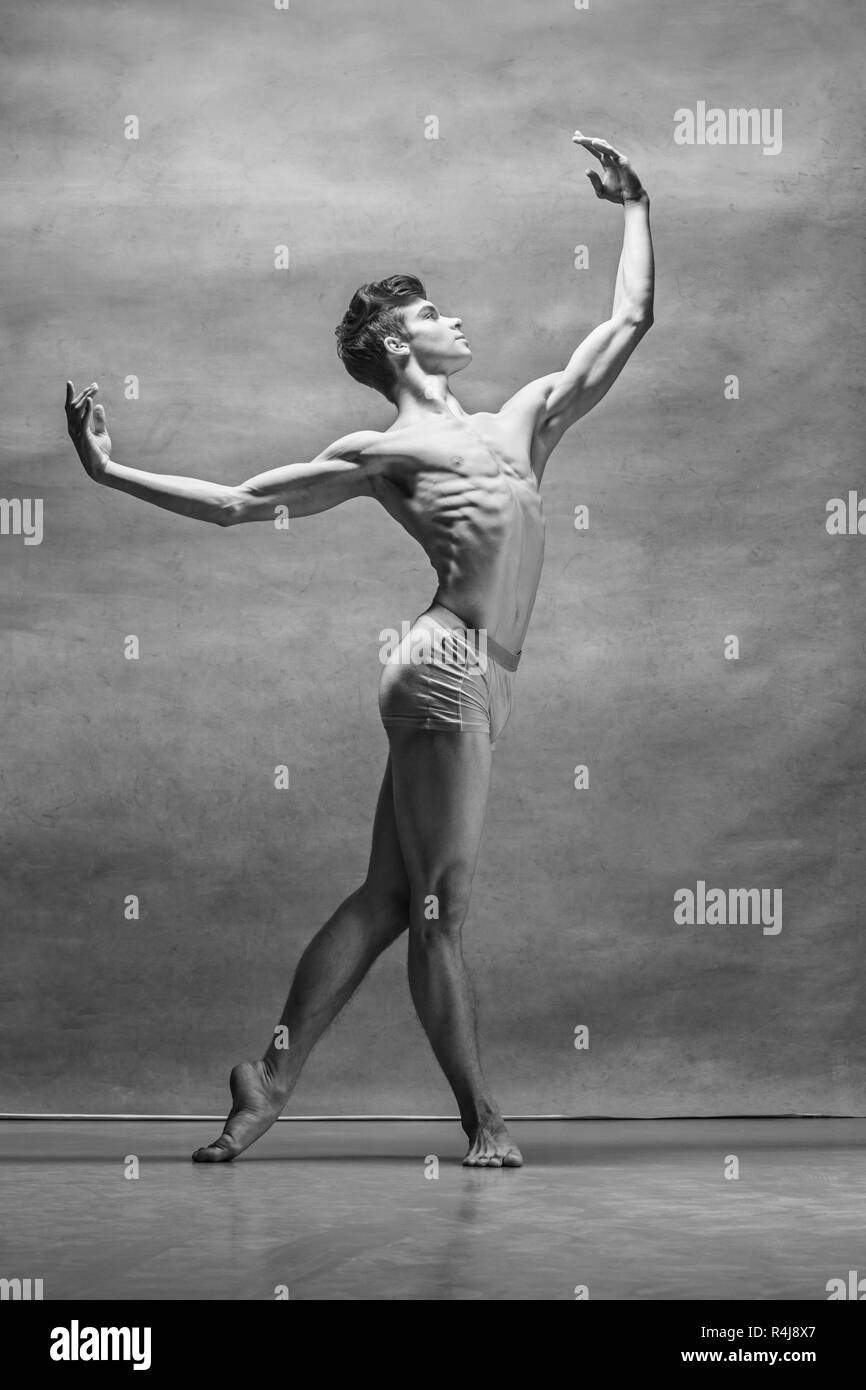 The male ballet dancer posing over gray background Stock Photo - Alamy
