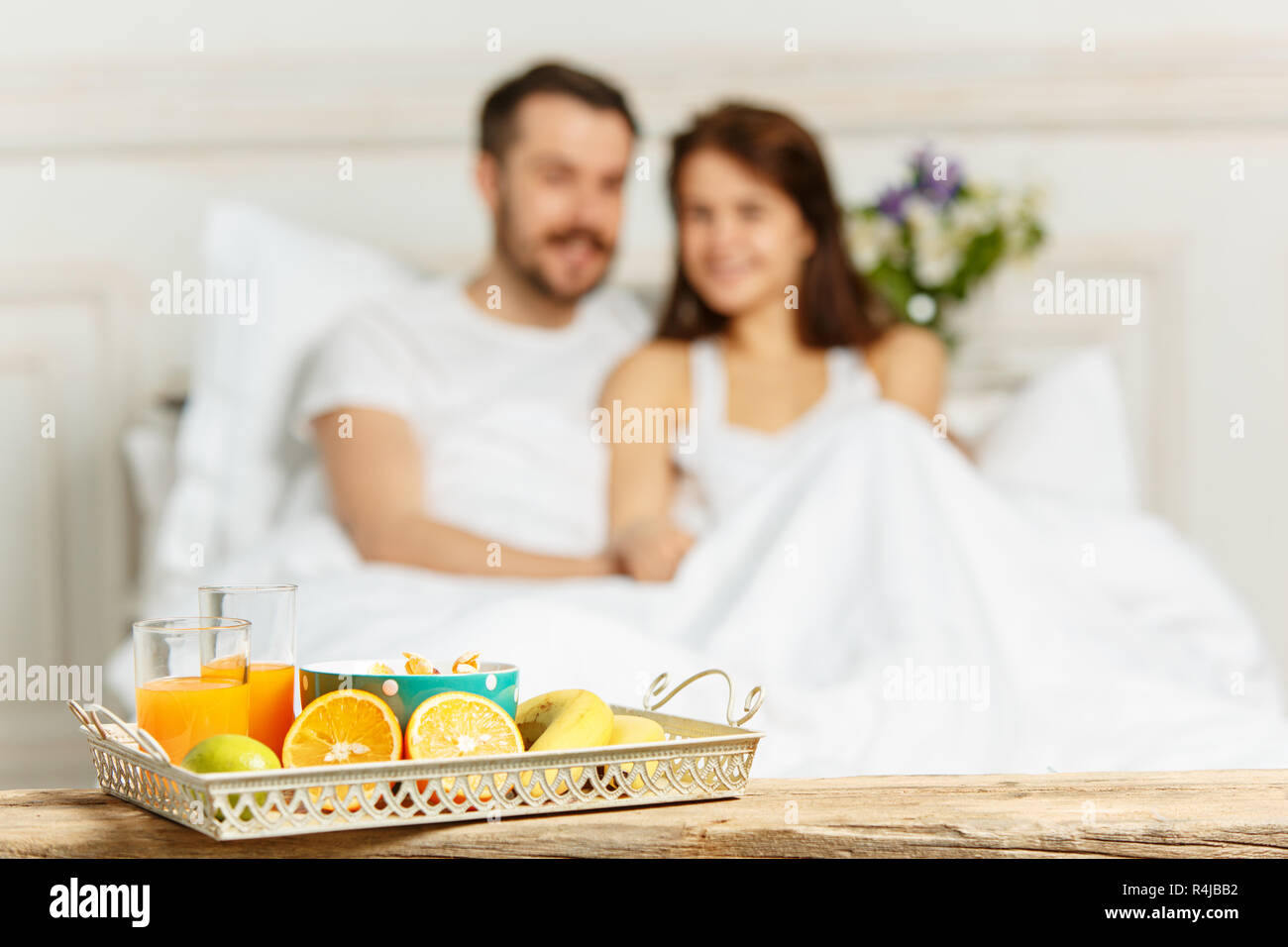 Relaxed Couple in Bed in bedroom at home Stock Photo - Alamy