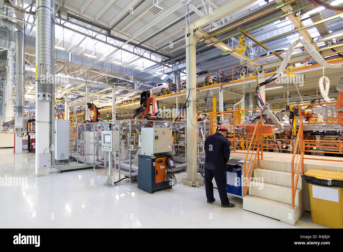 Workers assemble a vehicle body. process of welding cars. Modern ...