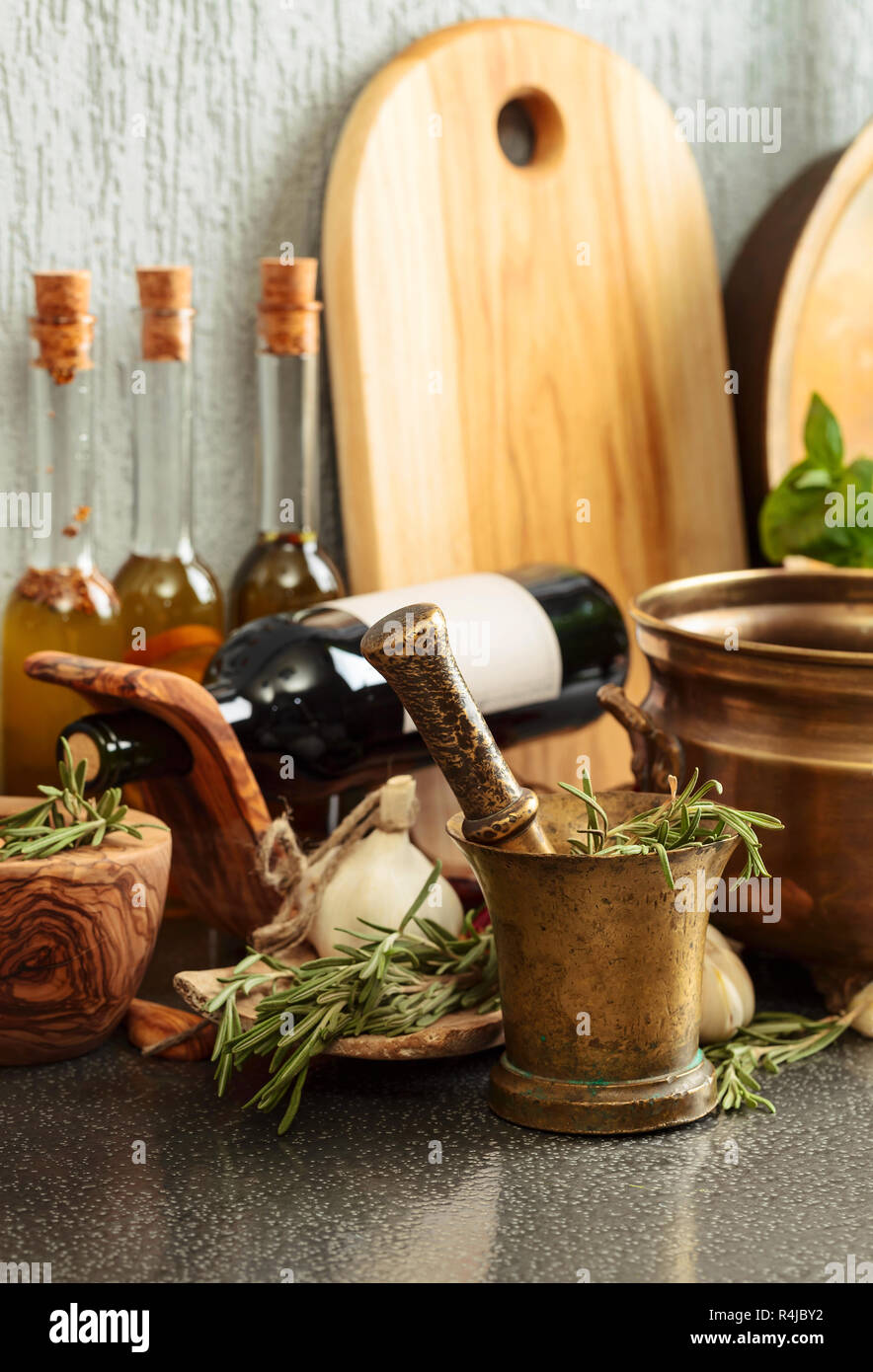 Vintage kitchen utensils with rosemary and bottles of olive oil. Olive ...