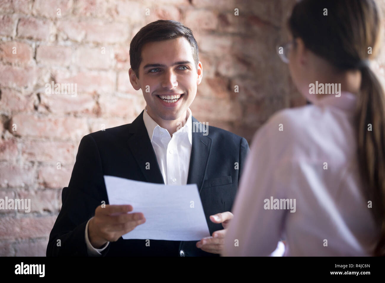 Happy hr manager with resume looking at female job seeker Stock Photo ...