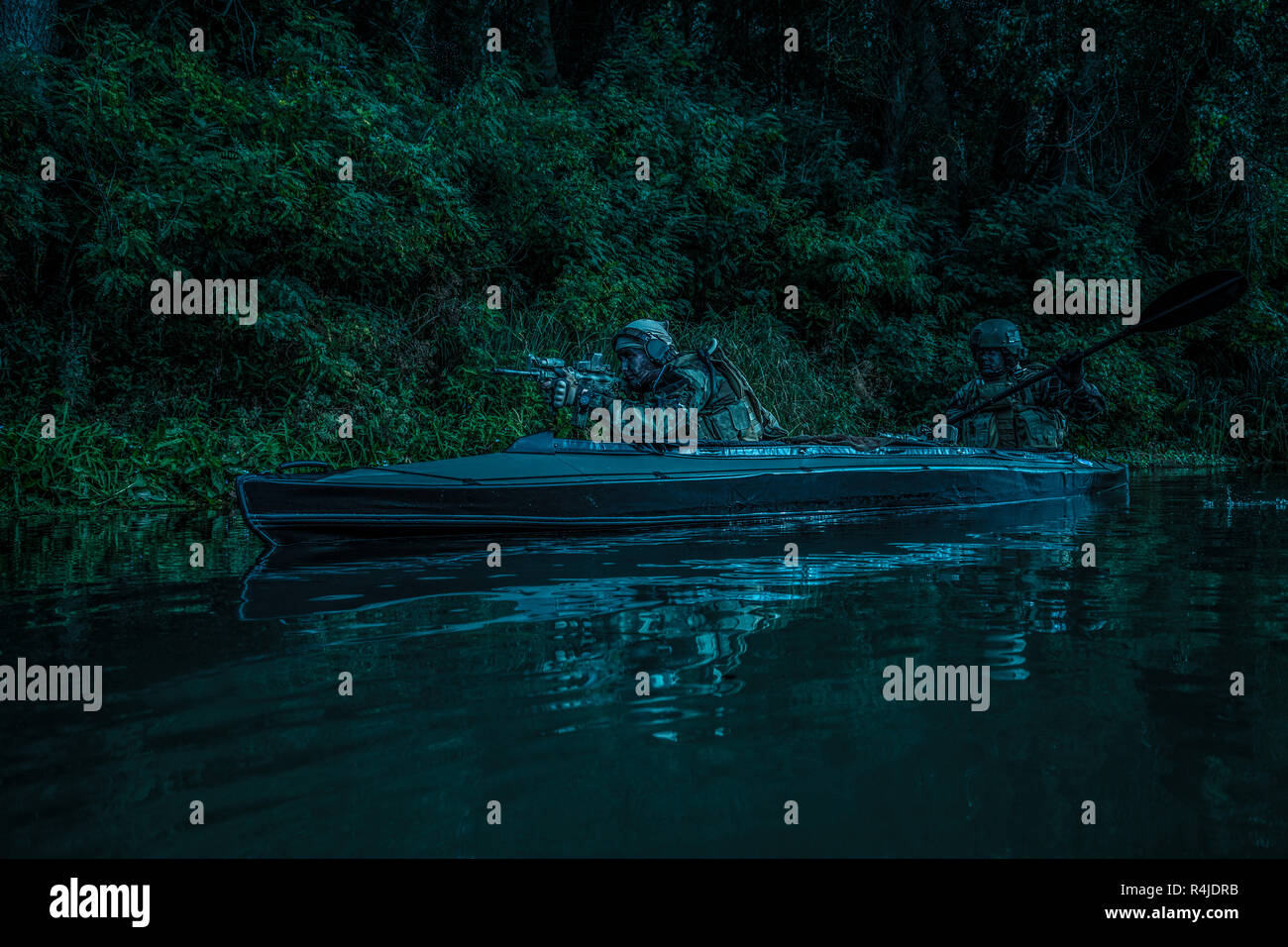 Militants in army kayak Stock Photo - Alamy