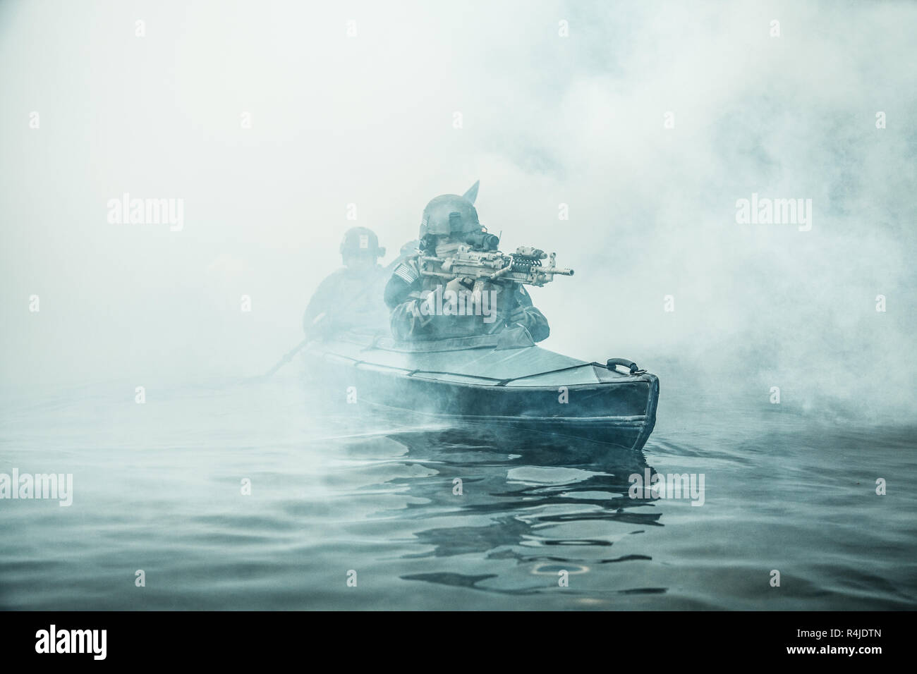 Militants in army kayak Stock Photo - Alamy