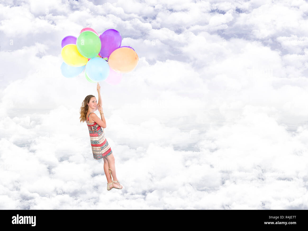 Girl flying balloons in sky hi-res stock photography and images - Alamy