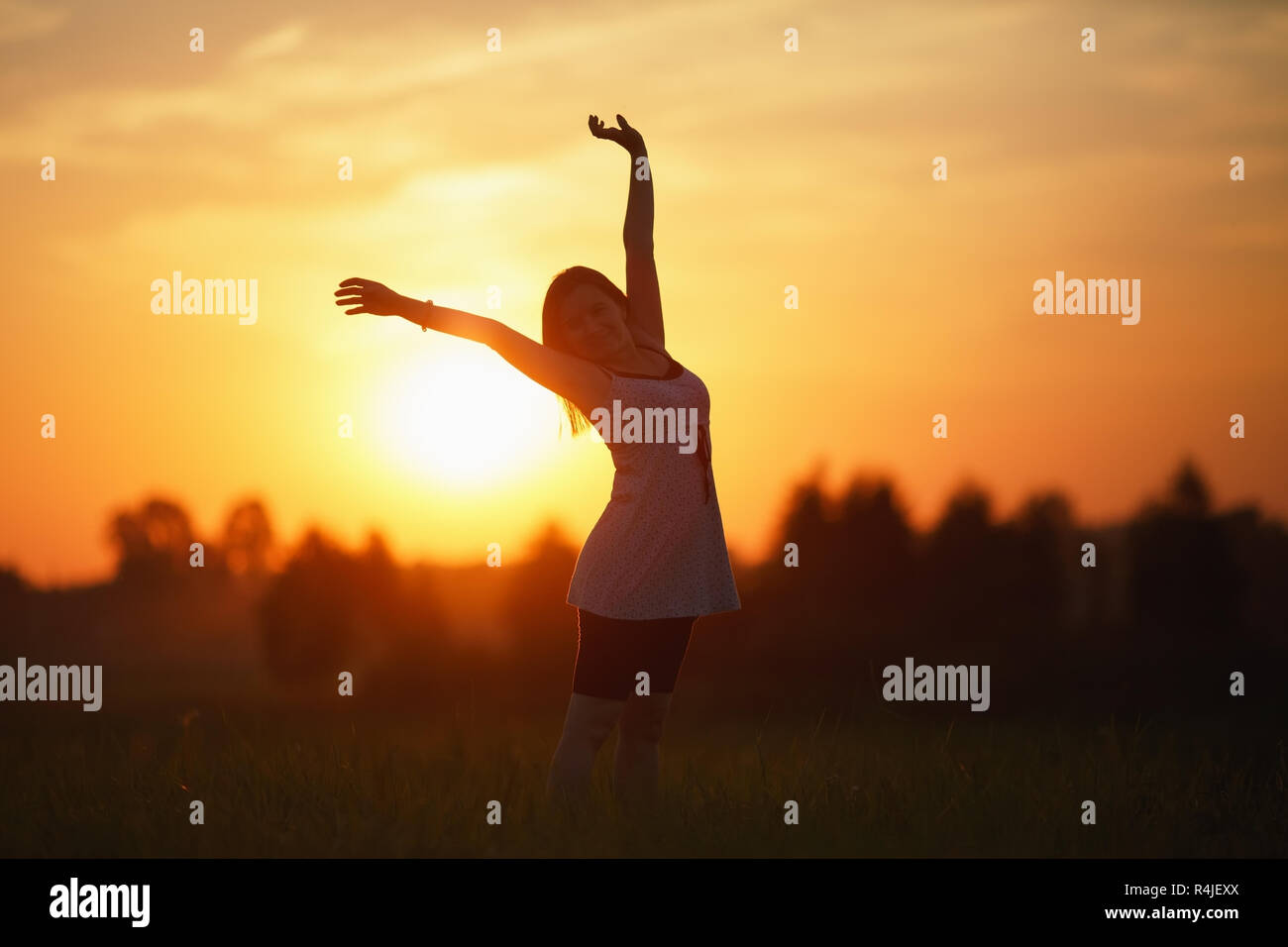 Woman on sunset background Stock Photo - Alamy