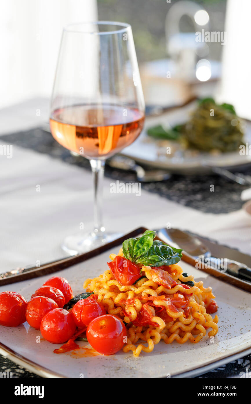 Light pasta lunch with glass of rose wine Stock Photo - Alamy