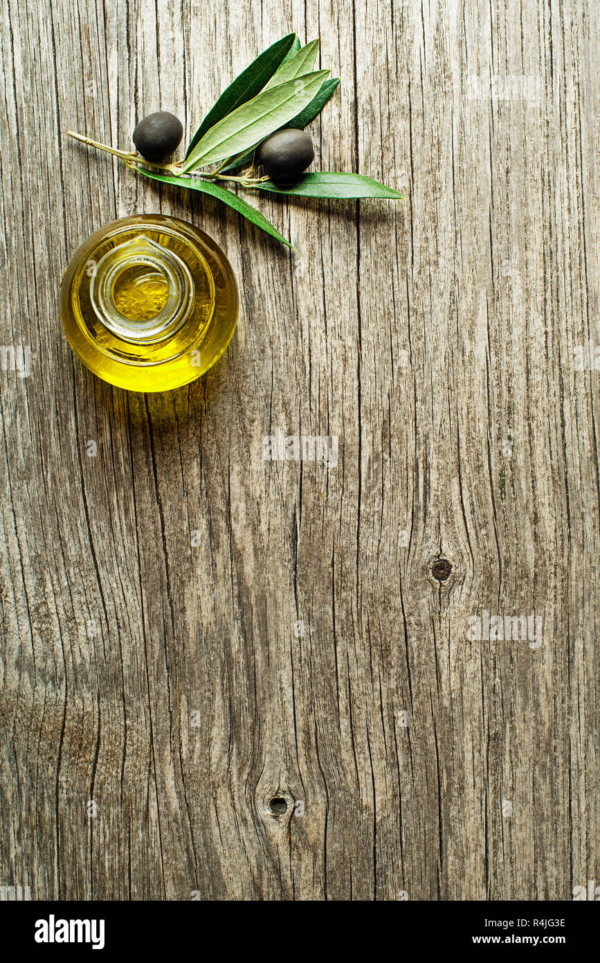 Bottle of Extra virgin healthy Olive oil with fresh olives close up ...