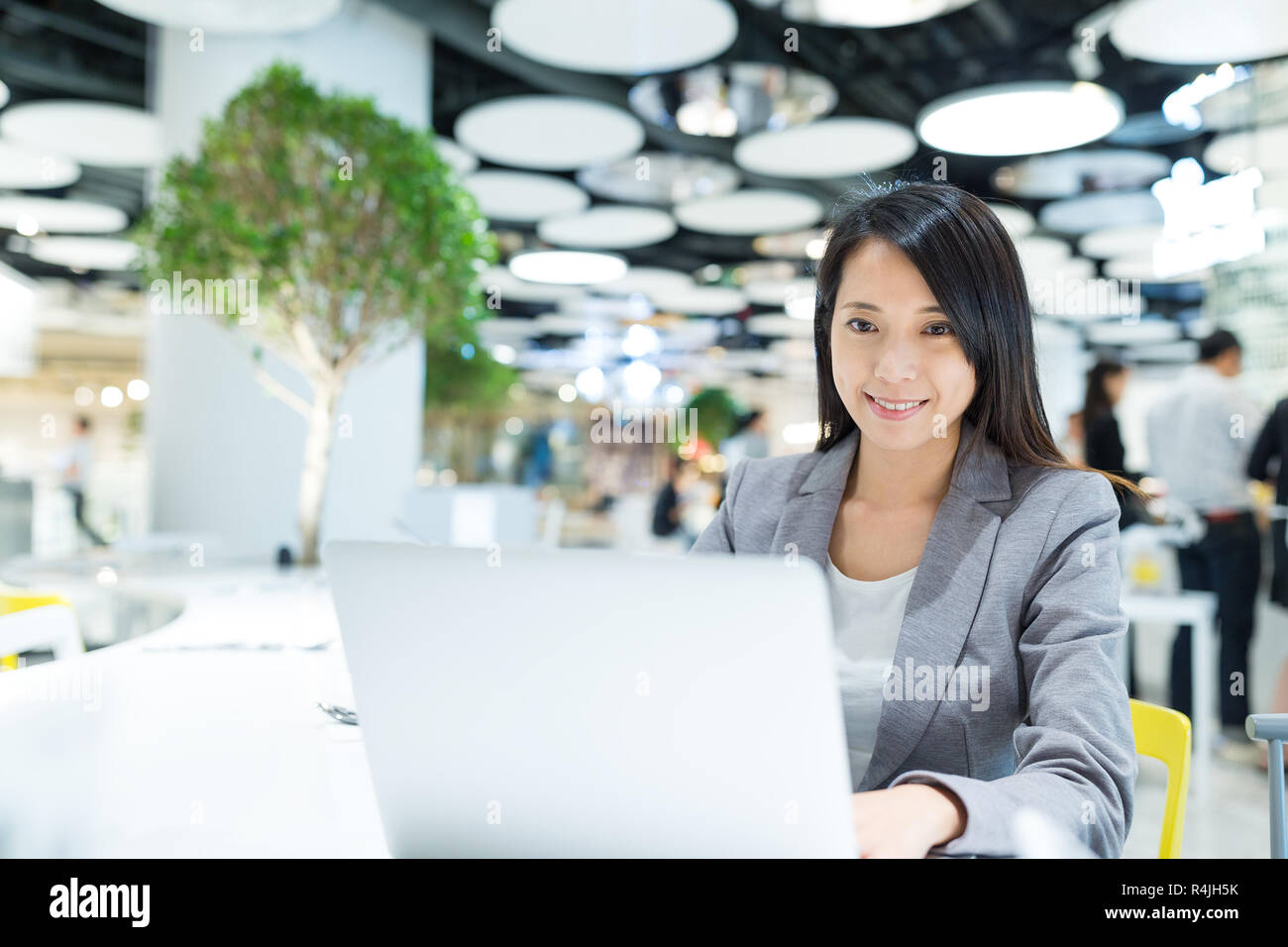 Businesswoman woking on laptop computer in meeting room Stock Photo - Alamy