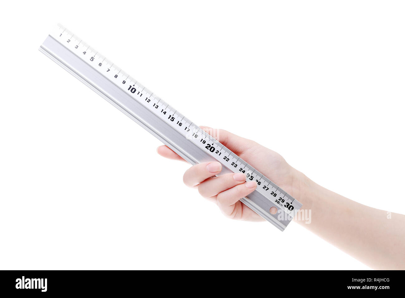 Hand holding metal ruler isolated on white background Stock Photo - Alamy