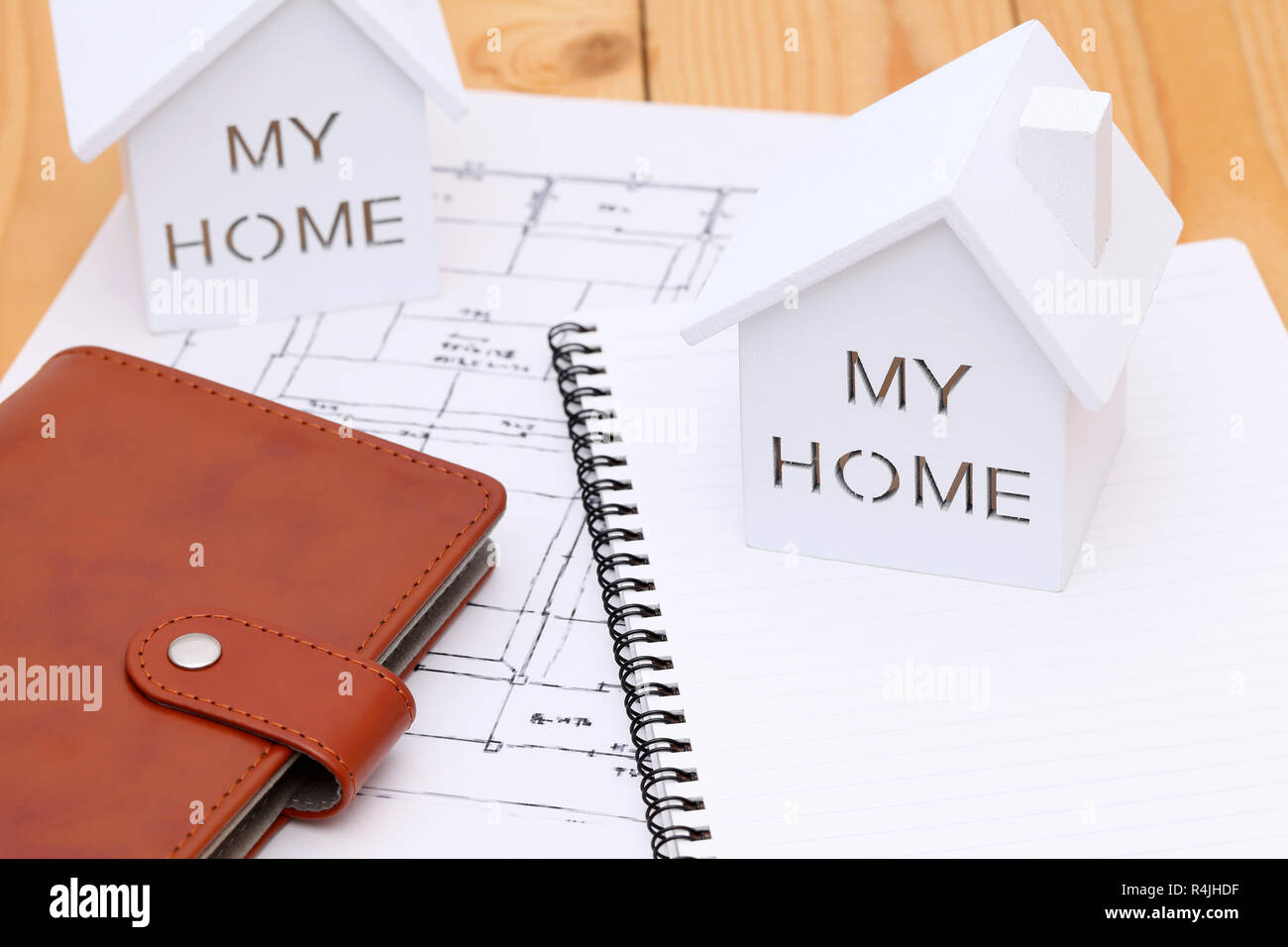 Miniature model of house and blueprints Stock Photo - Alamy