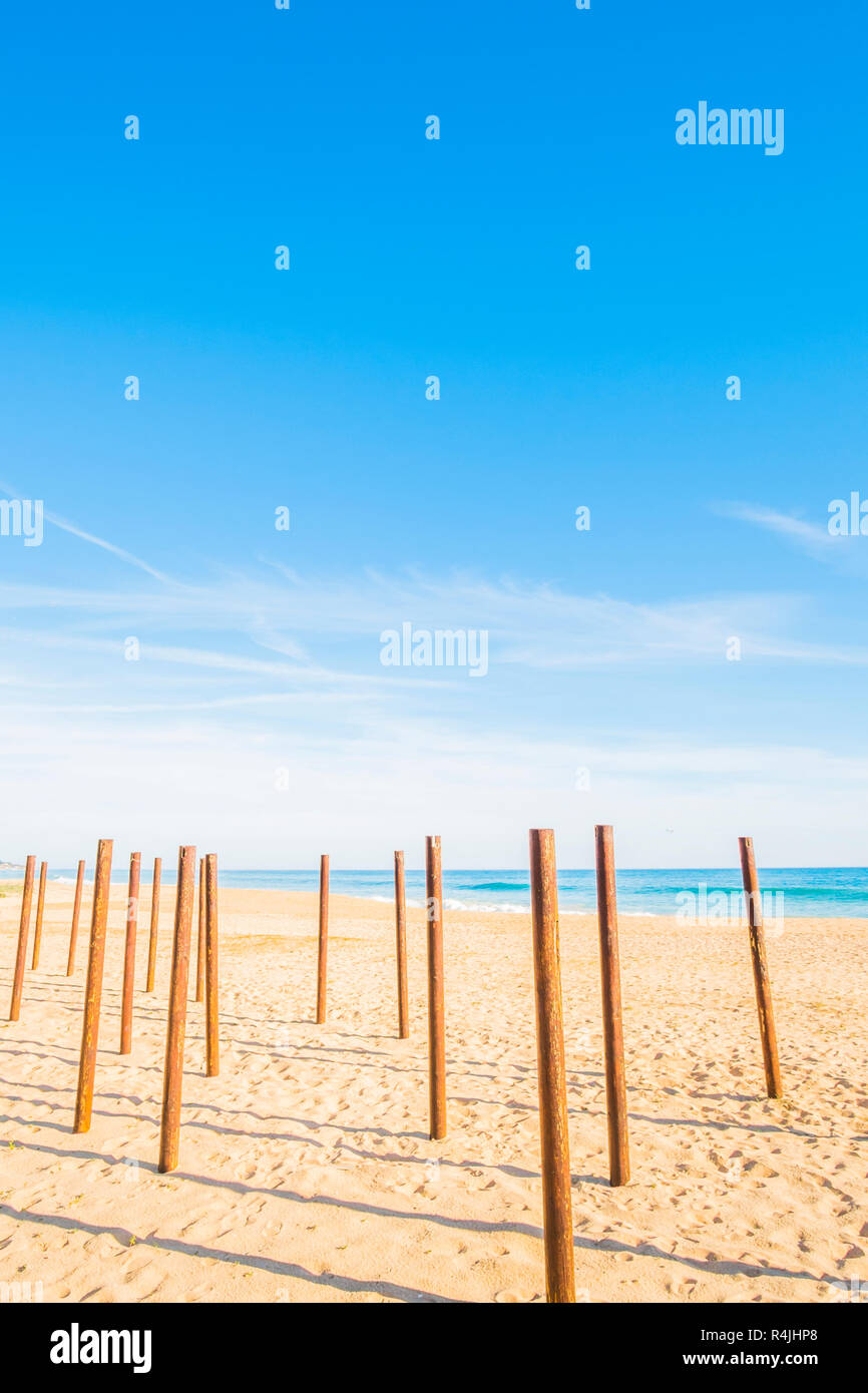poles at deserted beach Stock Photo - Alamy