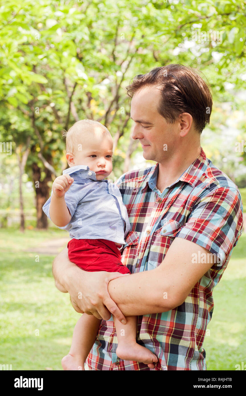 Father carrying son in park Stock Photo - Alamy