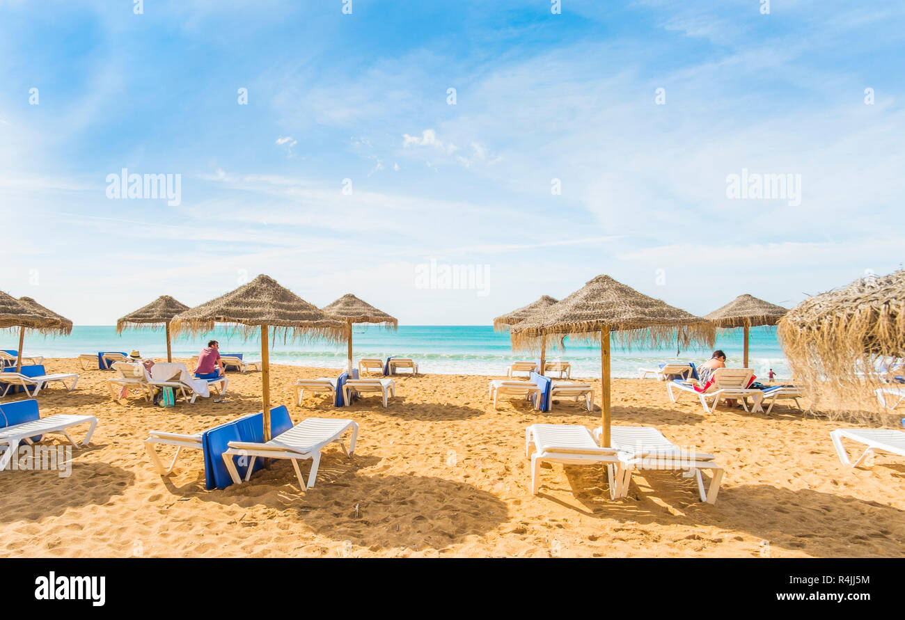 occasional tourists in pre-season at the beach Stock Photo - Alamy