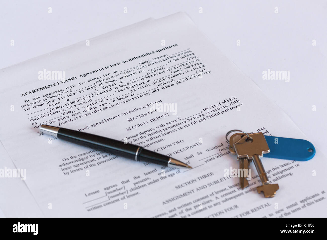 Lease / Rental agreement document with keys and pen. Contract in ...