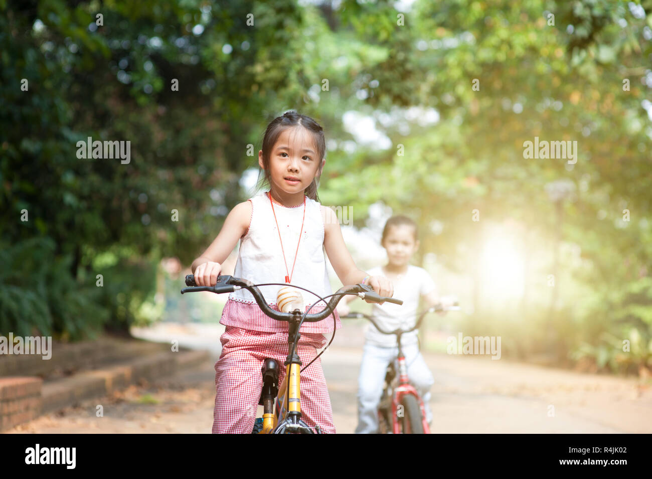 Children riding bikes outdoor Stock Photo - Alamy