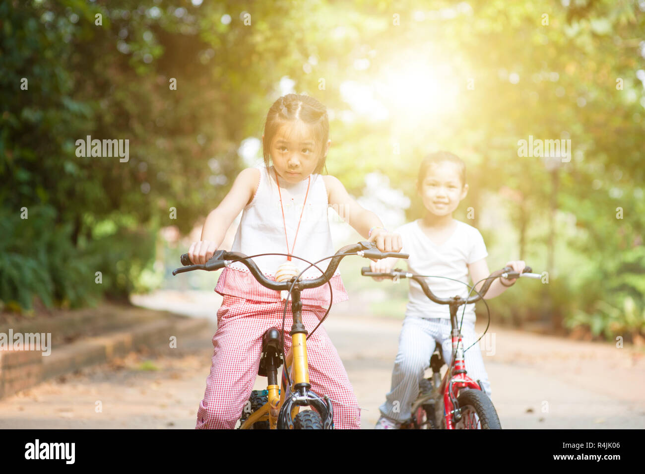 Children riding bikes outdoor Stock Photo - Alamy