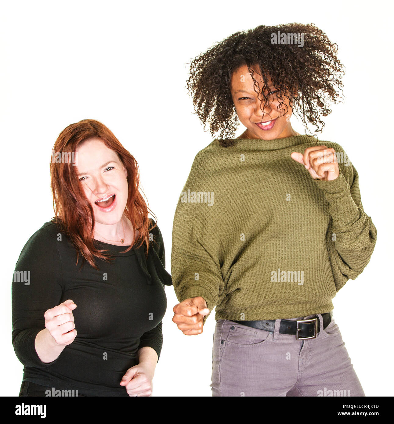 Two excited women dancing Stock Photo - Alamy