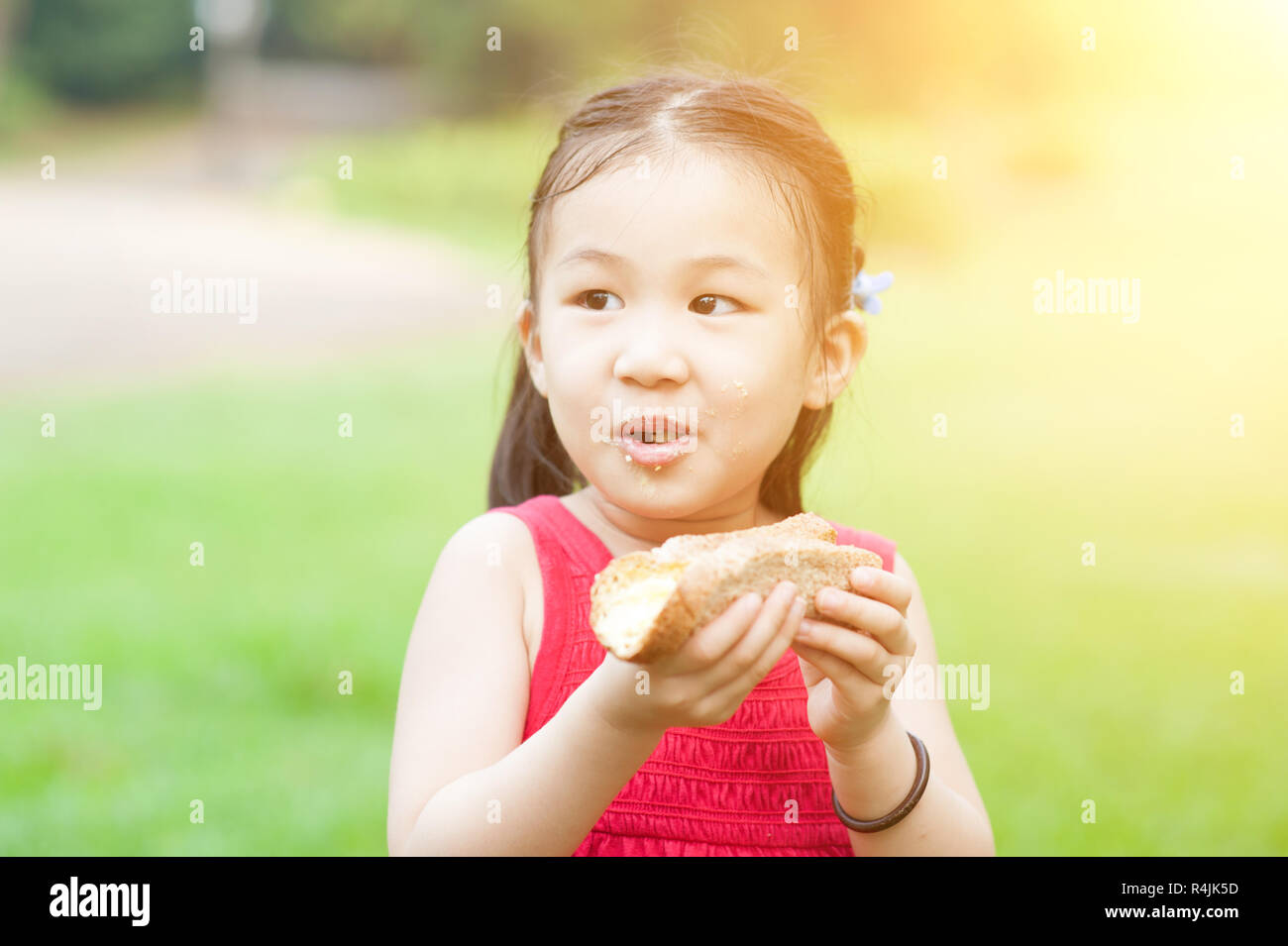 Portrait asian kid eating sandwich hi-res stock photography and images ...