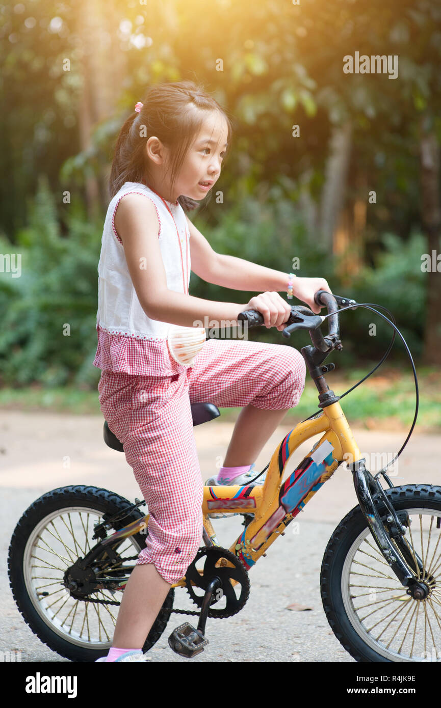 Asian child cycling outdoor Stock Photo - Alamy