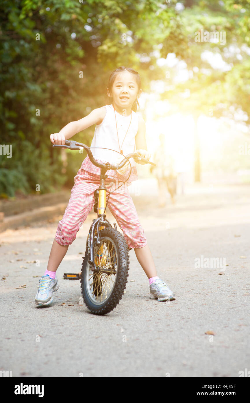 Asian child biking outdoor Stock Photo - Alamy