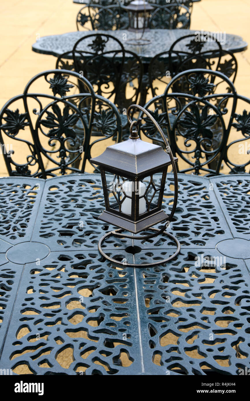 vintage lantern with chairs and table Stock Photo - Alamy