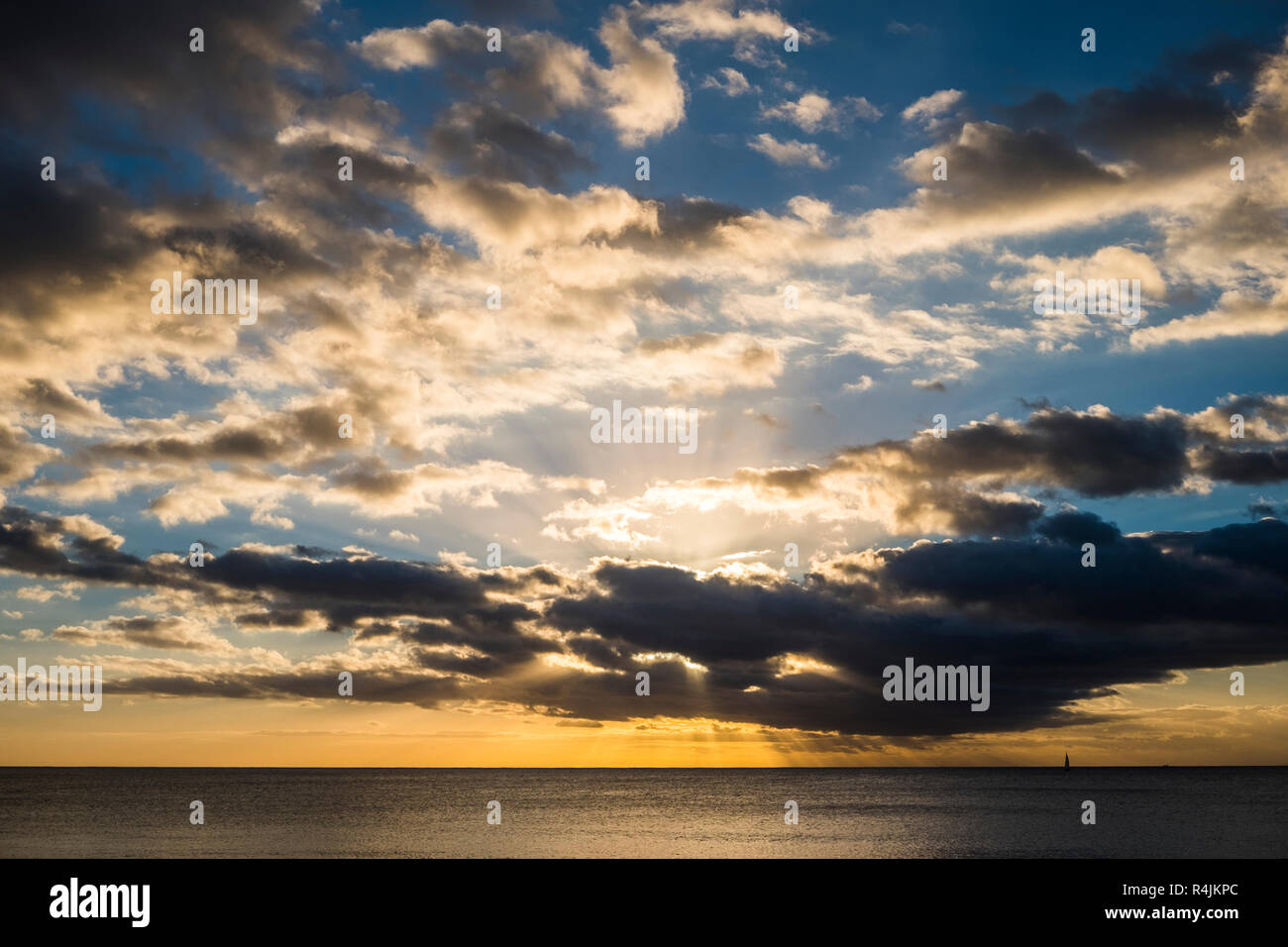 landscape of quiet ocean during a coloured beautiful sunset with lot of ...