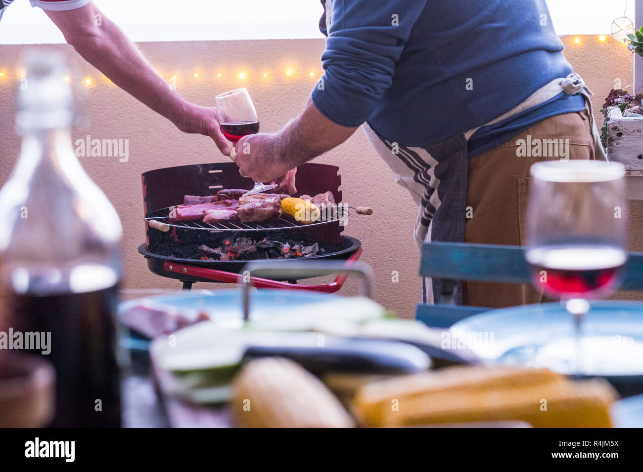 closeup with defocused tabler of grill with meal on the flame - cook ...