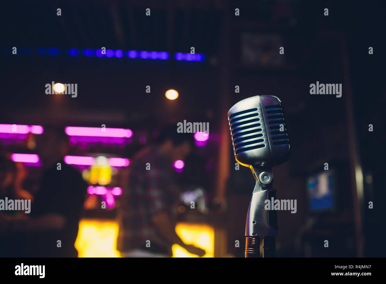 Retro microphone on stage in a pub or American Bar restaurant during a ...