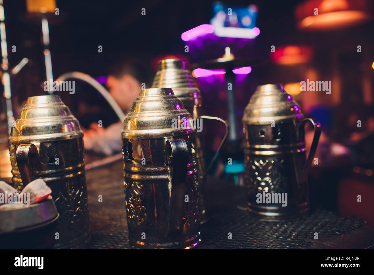 Group of metal shisha pipe cover on the shelf for burning charcoal ...